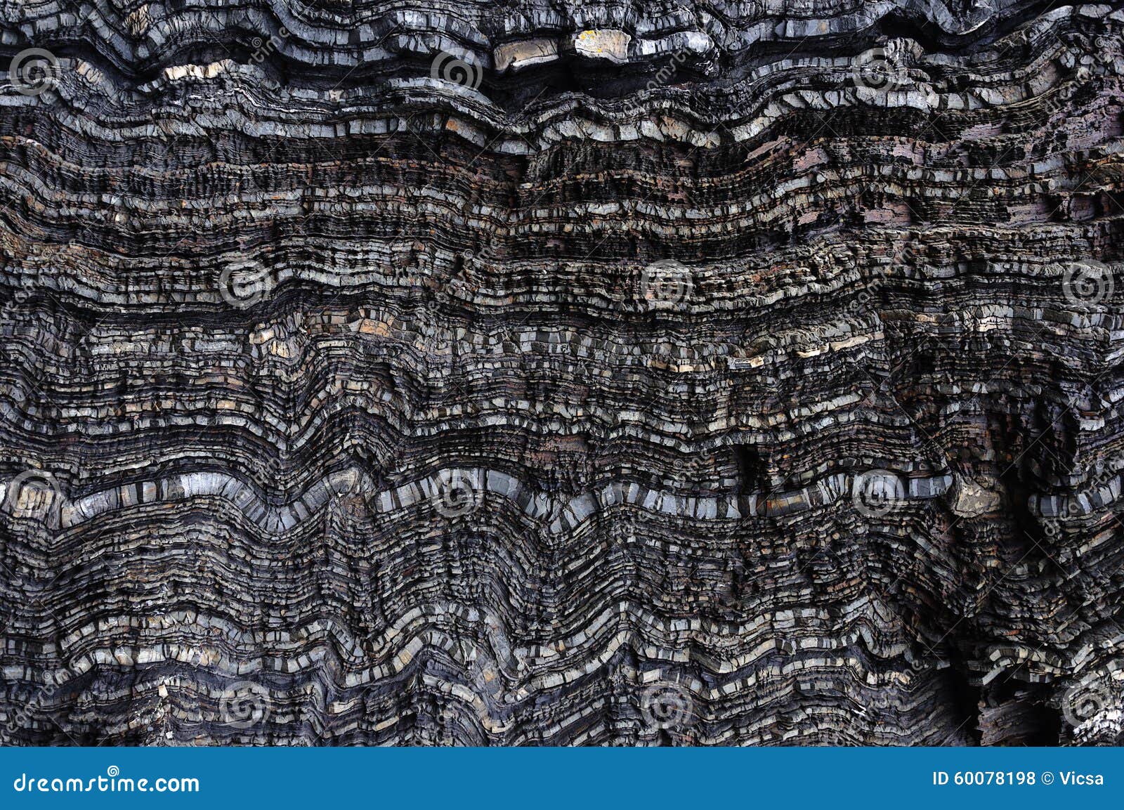 Black wavy layers of rock stock photo. Image of mineral - 60078198