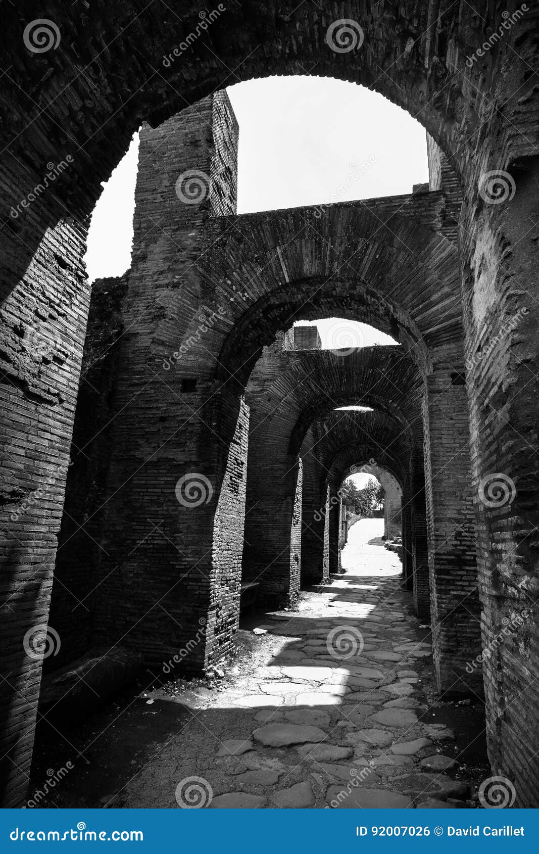 Black and White of Ancient Roman Arches Repeating Over a Stone Pathway ...