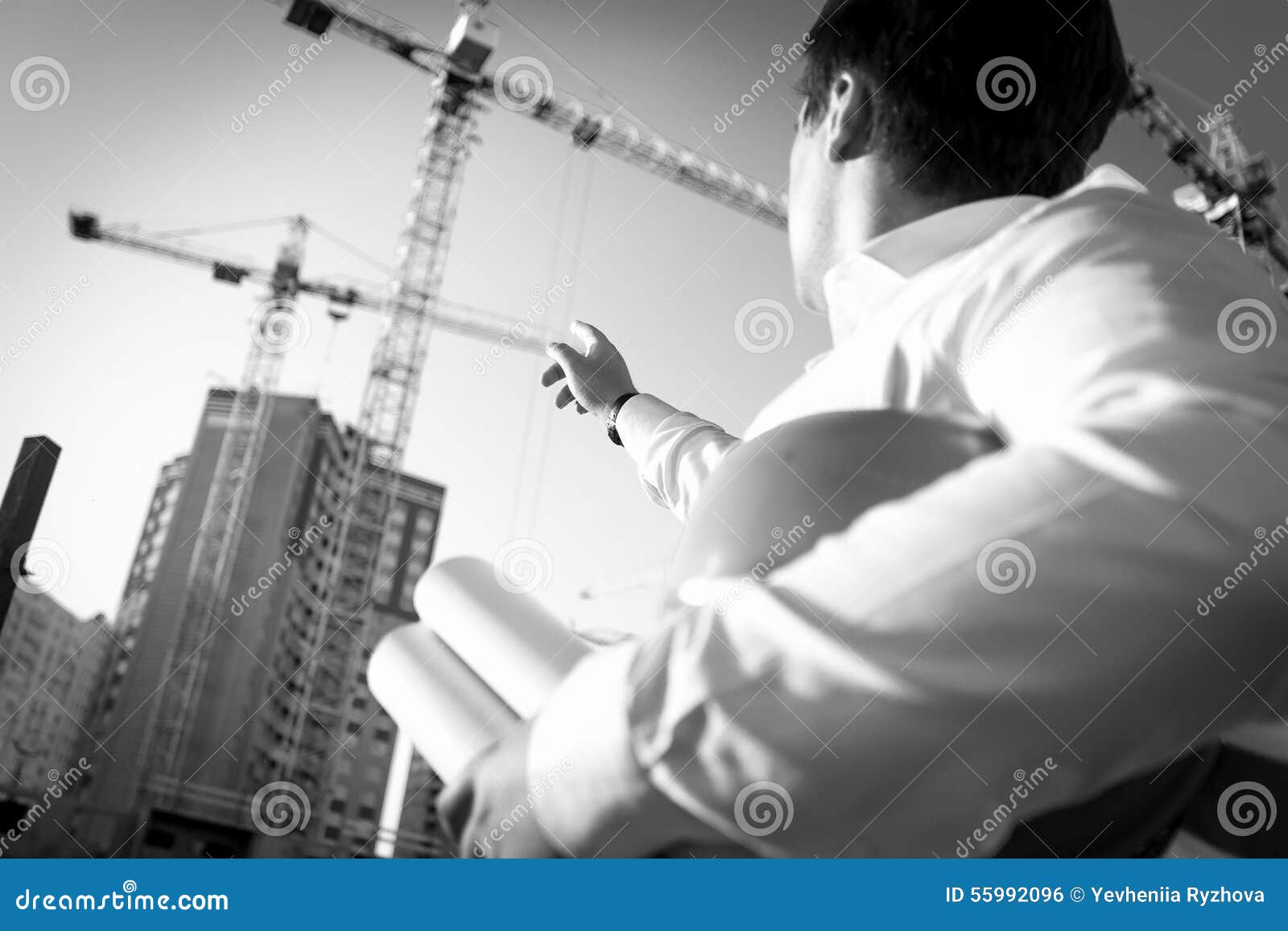 Black and White Closeup of Engineer Pointing at the Building Stock ...