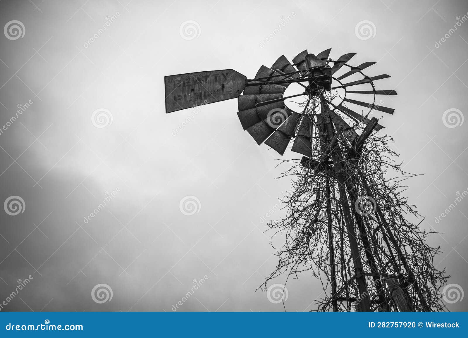 And White Image of an Abandoned Windmill with Ominous Dark Clouds in ...