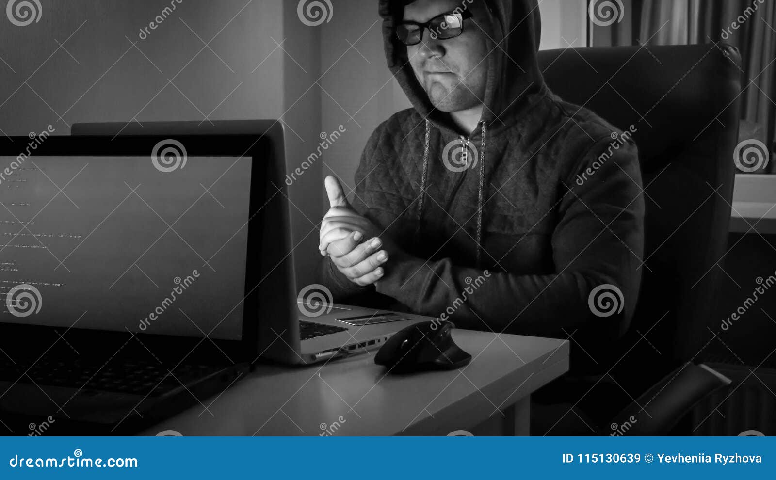 Black and White Image of Hacker Smiling after Stealing Money from ...