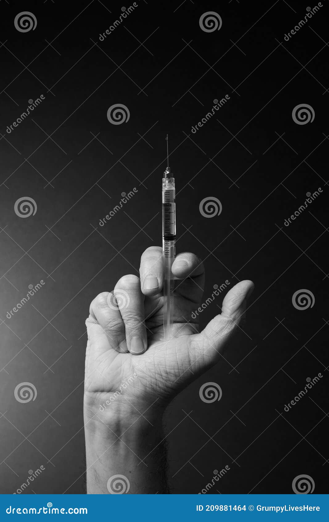 Man`s Hand Holding Syringe with Dramatic Lighting Stock Photo - Image ...