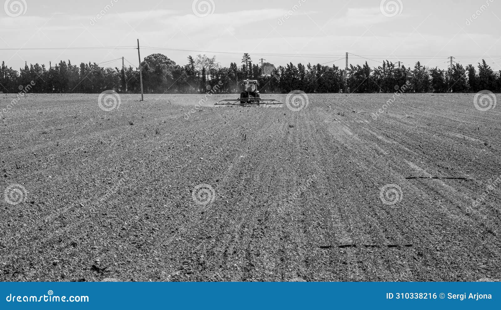 Black and White Image of a Tractor Plowing in the Middle of the Field ...