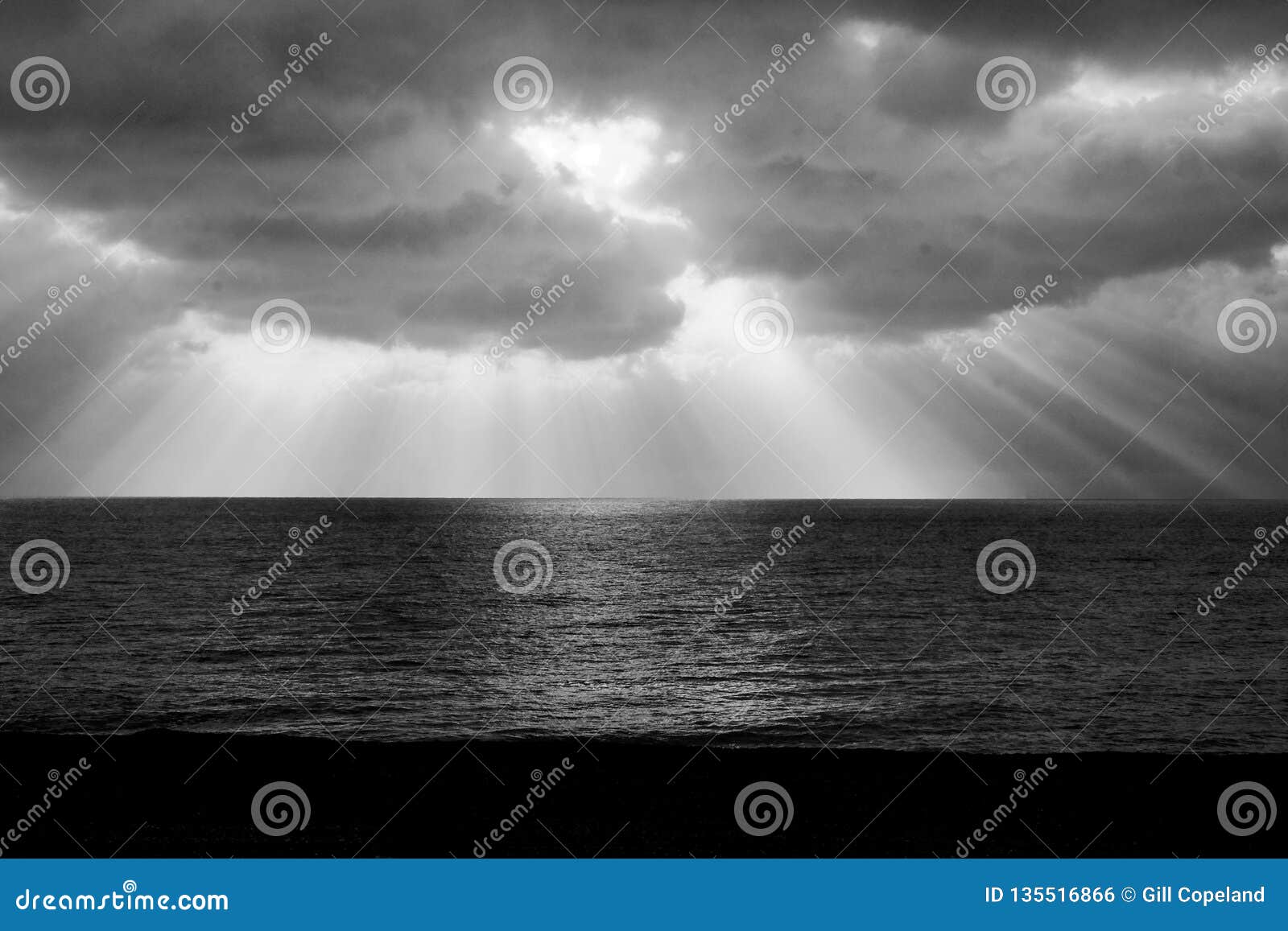 Sunbeams of Light Rays Shining through Dramatic Clouds Onto the Sea in ...