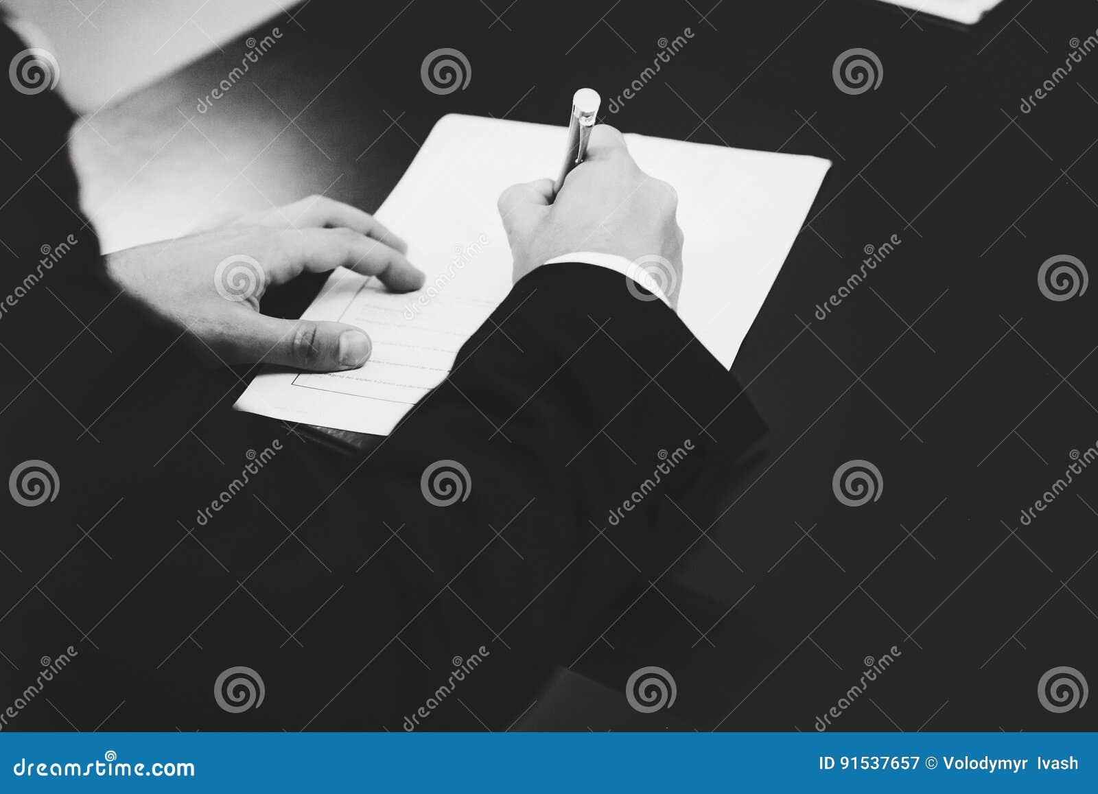 A Black and White Picture of a Man Signing Papers Stock Image - Image ...