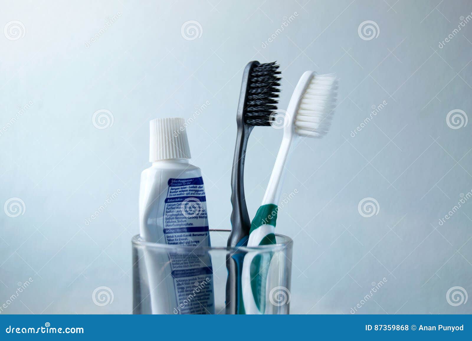 Black and White Toothbrush and Toothpaste in Glass Stock Photo - Image ...