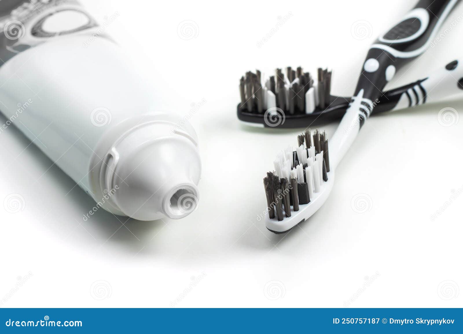 A Black and White Toothbrush with Toothpaste on White Background with ...