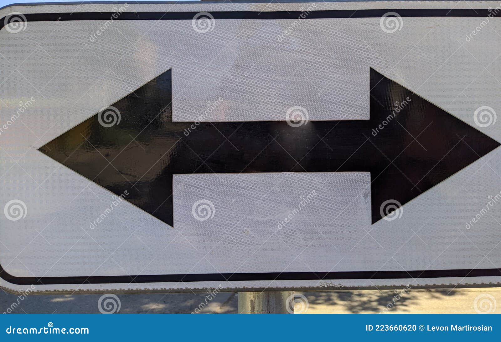 Black and White Traffic Sign with Arrows Pointing To the Left and To ...