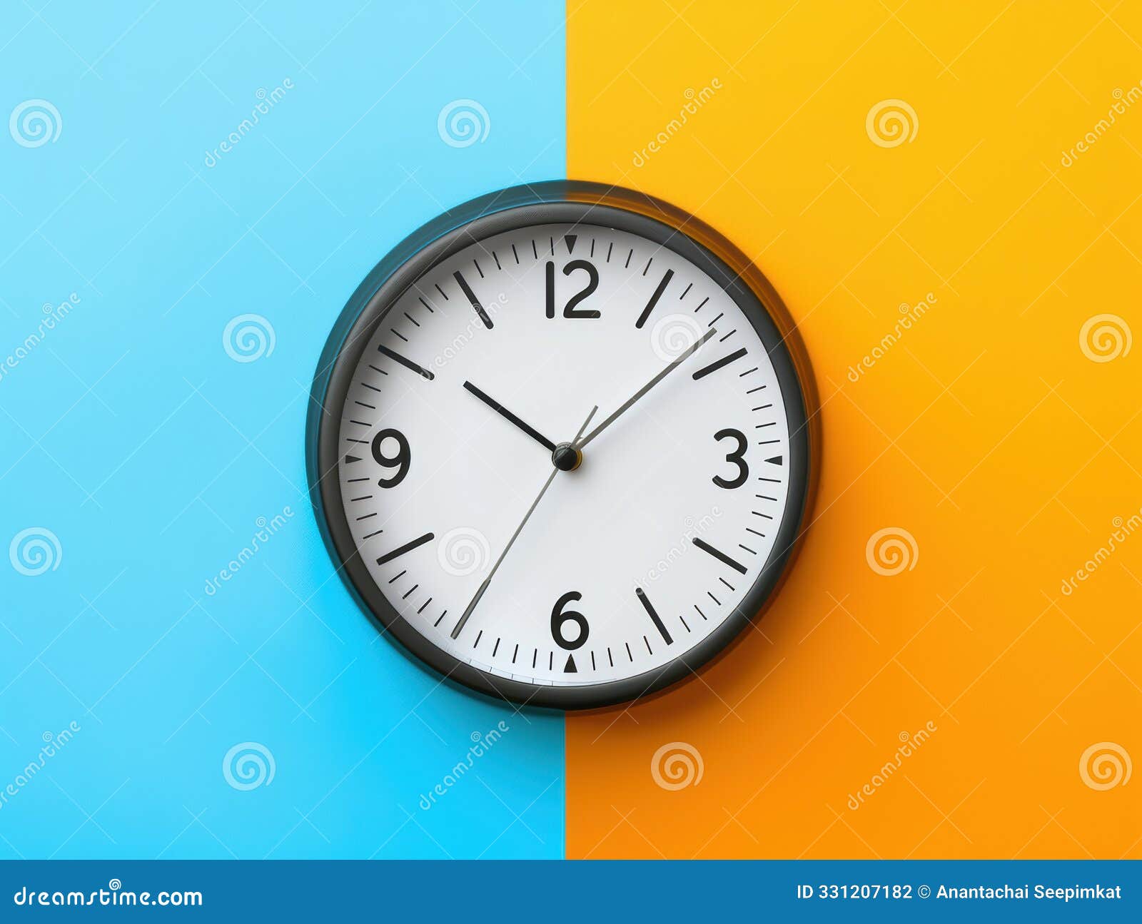 A Black and White Wall Clock Centered on a Split Blue and Yellow ...