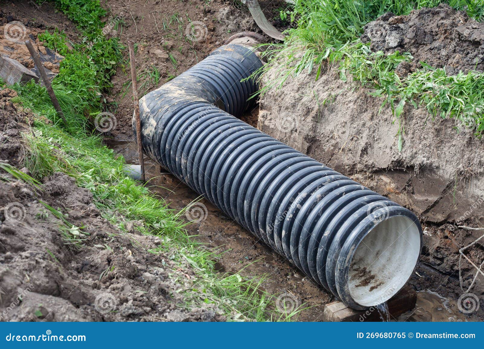 Black Wide Pipe Lies at an Angle in the Ditch in the Summer Stock Image ...