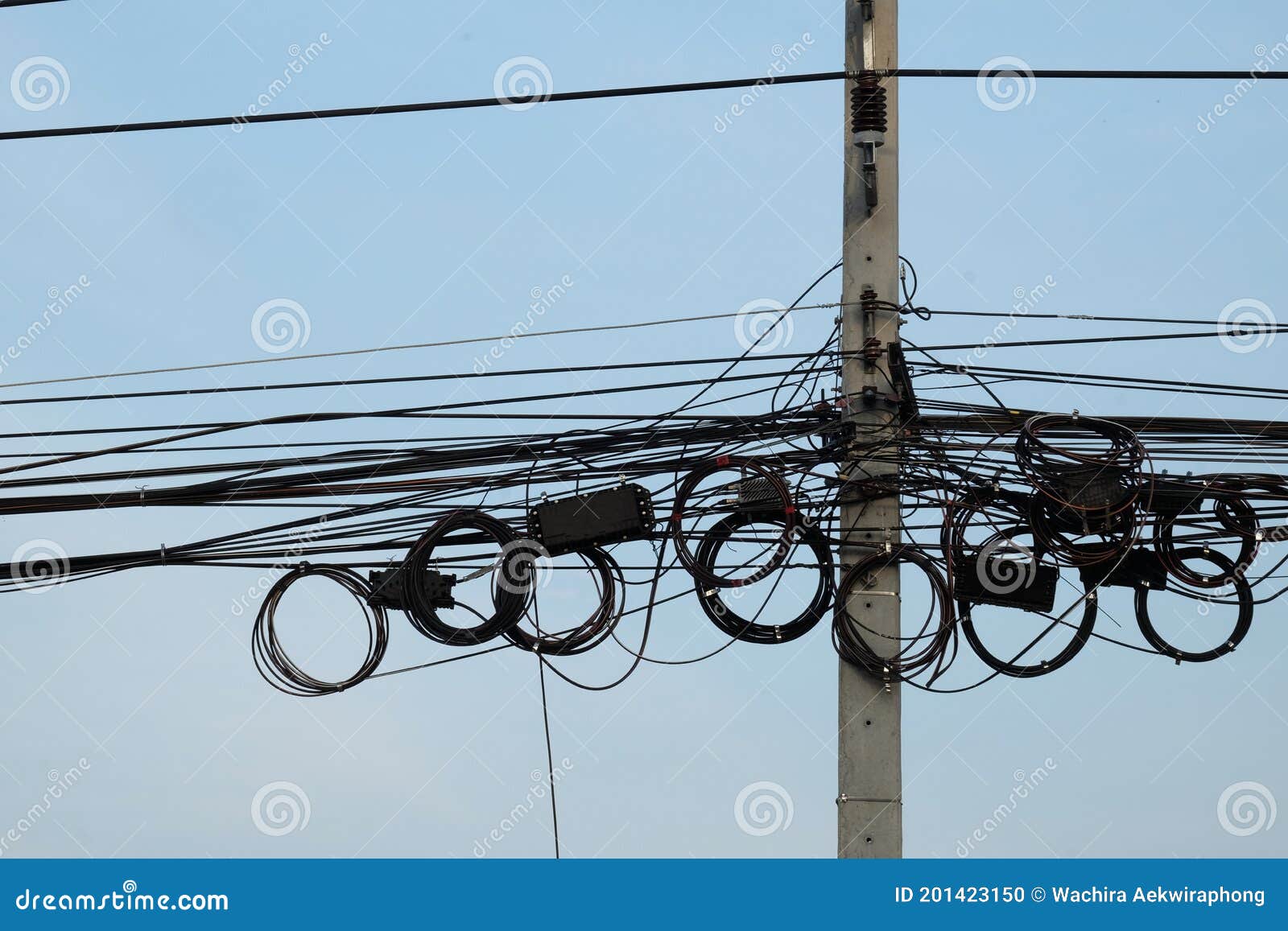 Black Wires Neatly Rolled Up on the Electric Pole Stock Photo - Image ...