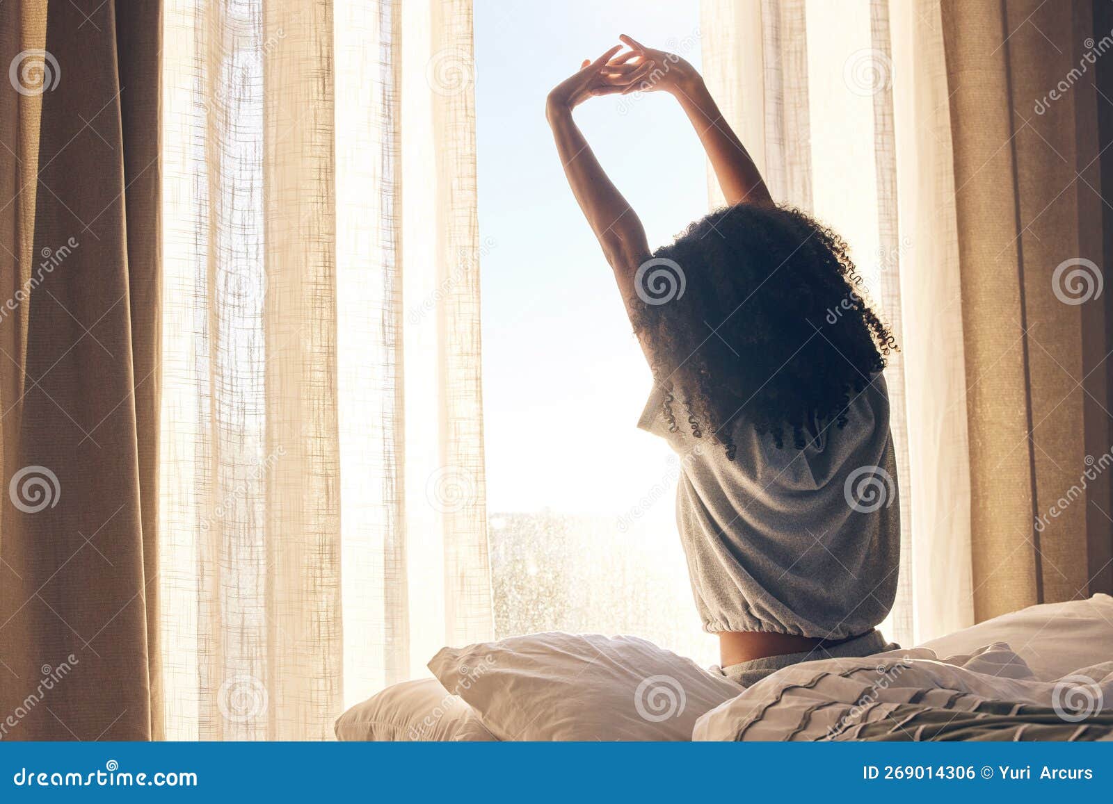 Black Woman Back Stretching And Waking Up In Home Bedroom After