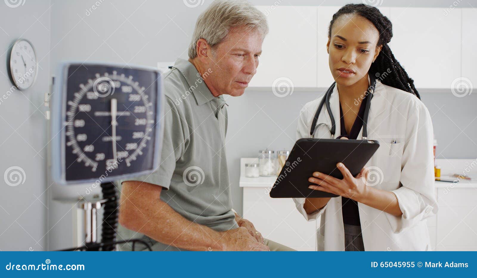 Black Woman Doctor Talking with Senior Patient in the Office Stock ... Black Woman Doctor Talking with Senior Patient in the Office Stock ...