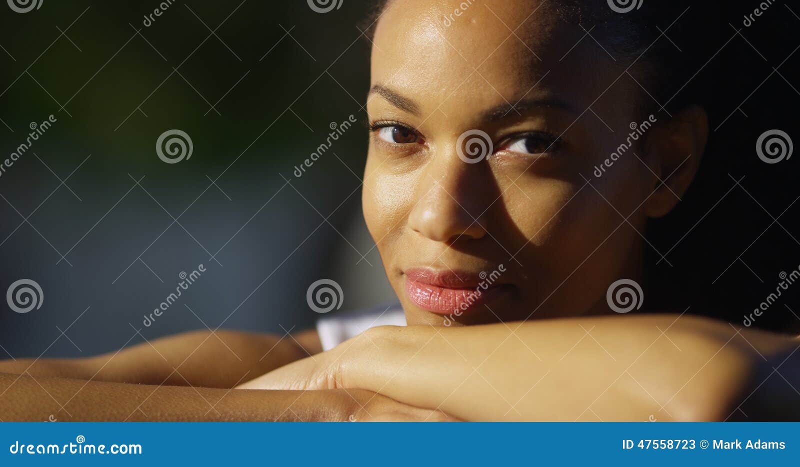 Black Woman Resting on Arms Looking at Camera Stock Image - Image of ...