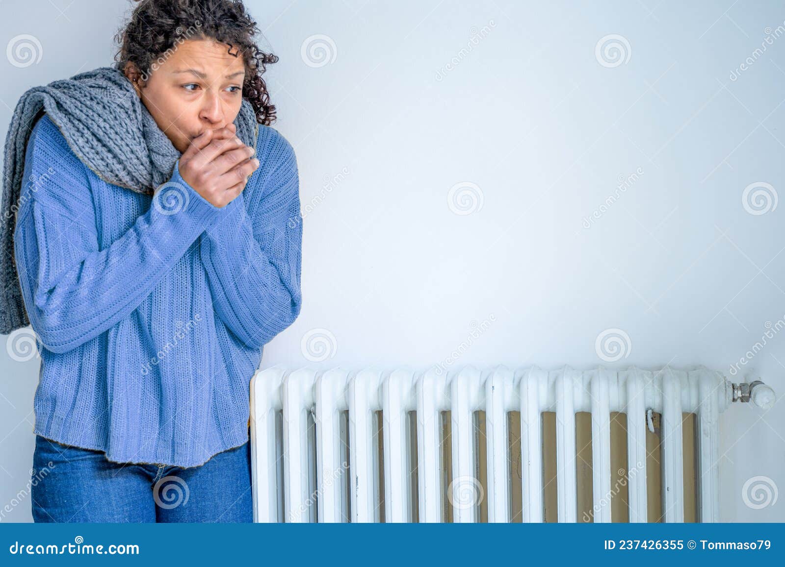 Black Woman Suffering Cold at Home because of Home Heating Problem ...