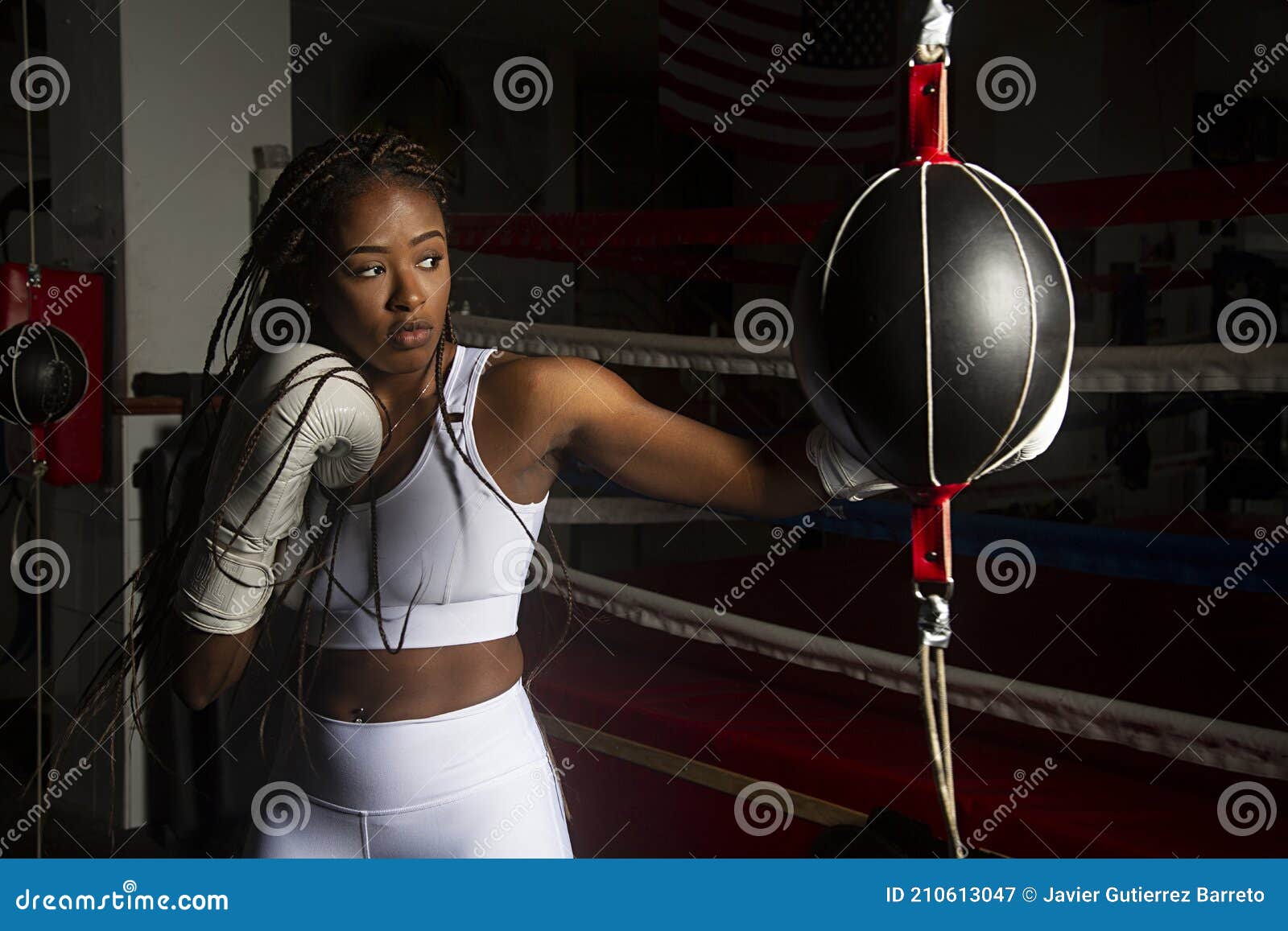 Black Woman Training Boxing in Gym with the Ring Boxing Background ...