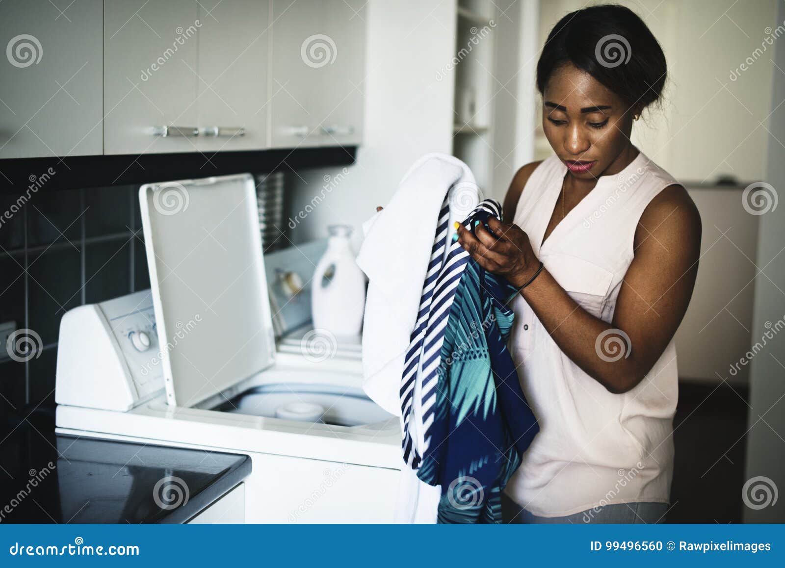 Black Woman Using Washing Machine Doing the Laundry Stock Photo - Image ...