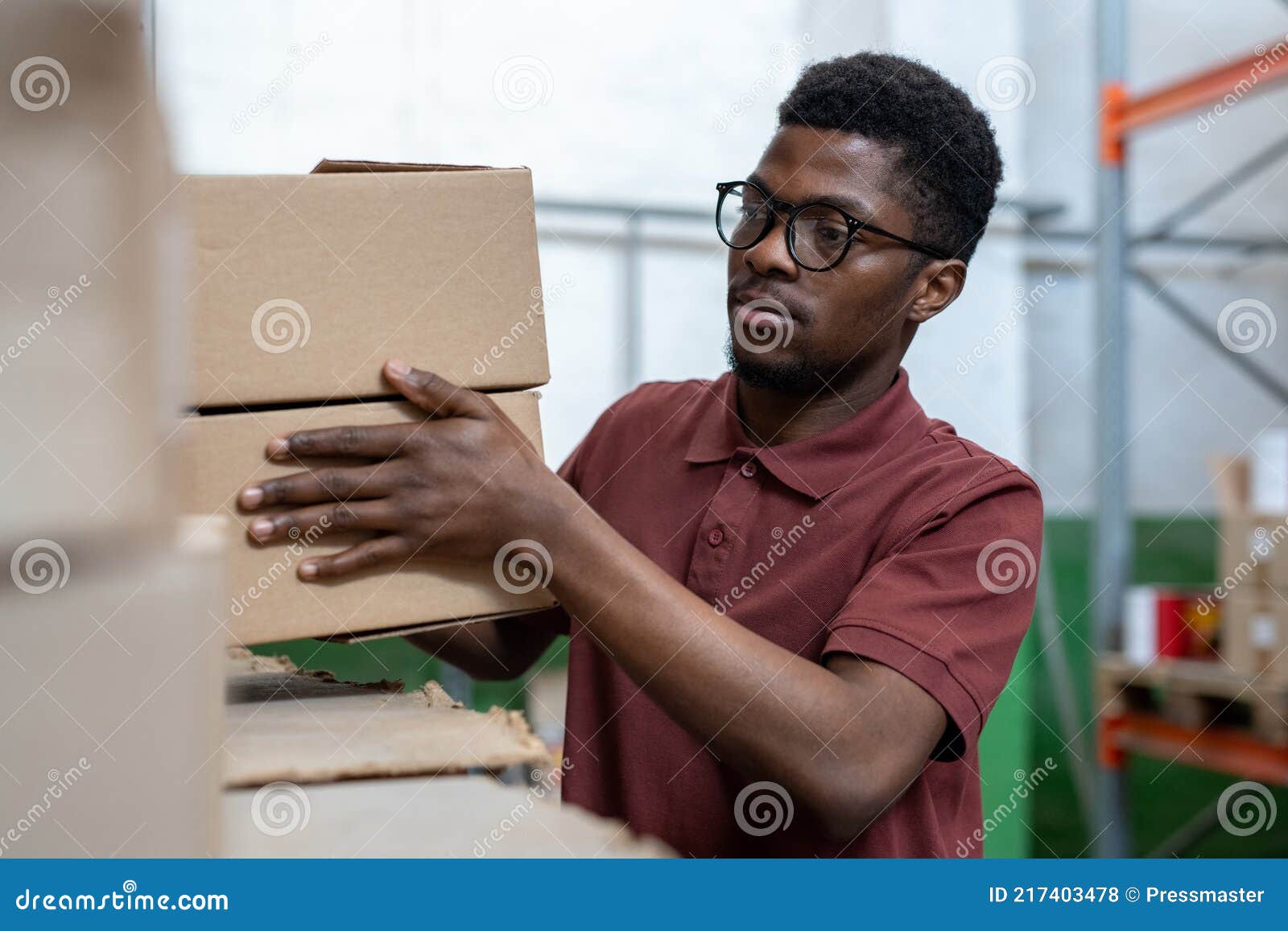 Black Worker Stacking Boxes on Shelf Stock Photo - Image of smiling ...