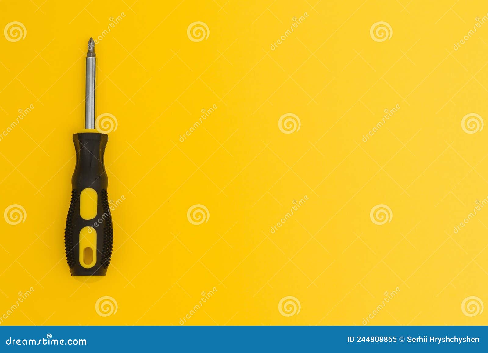 Black and Yellow Screwdriveron a Yellow Background with Space for Text ...