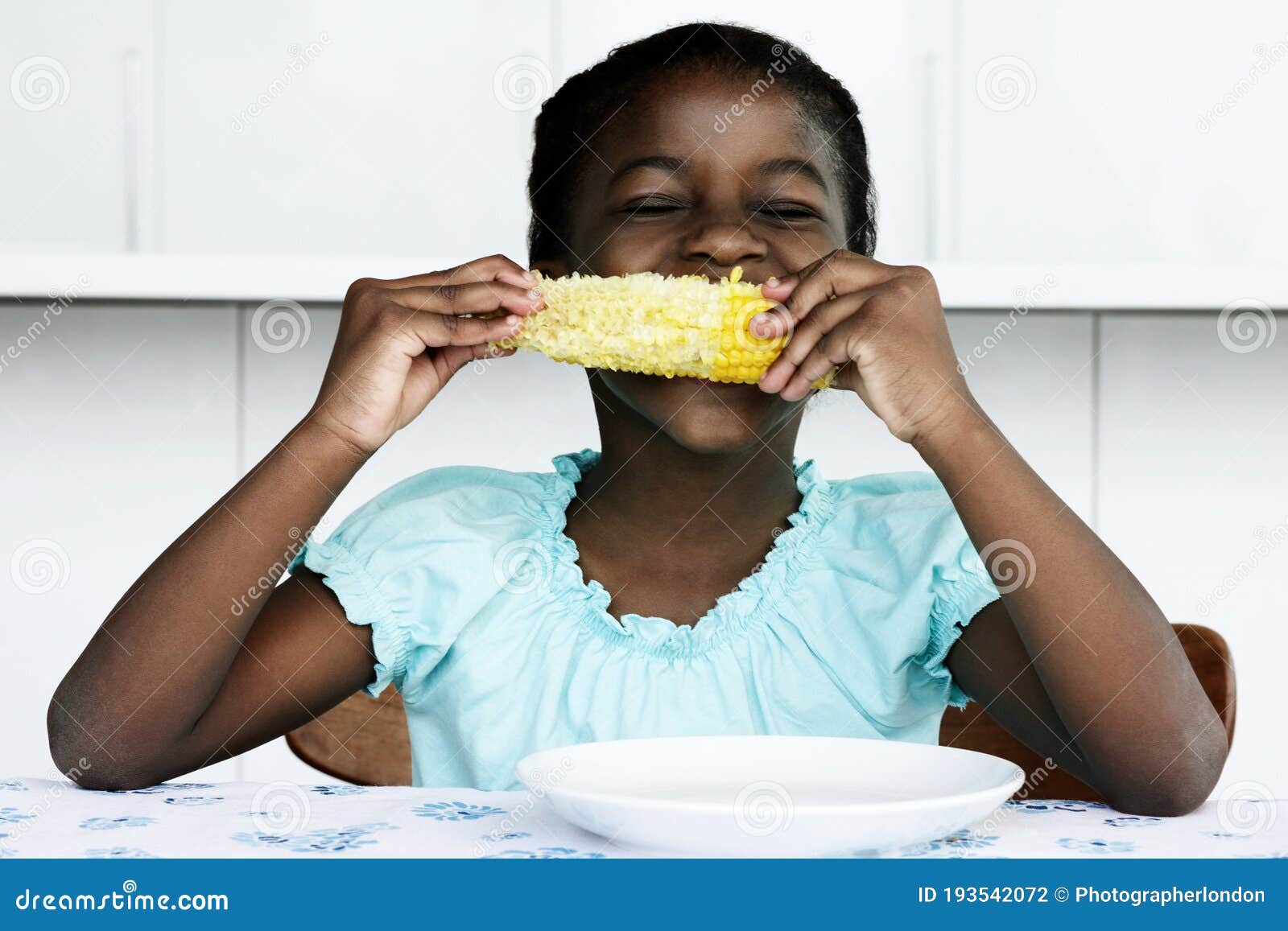 Black Young Girl Eating Corn Stock Photo - Image of entertainment, hand ...