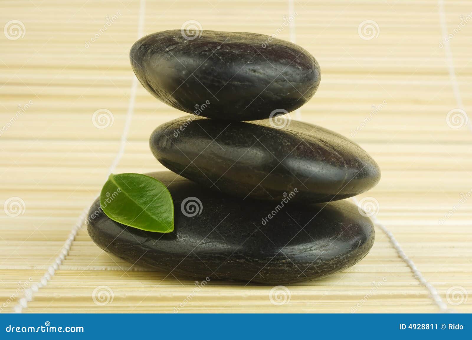 Black Zen Pebbles and Green Leaf on Bamboo Stock Image - Image of stack ...