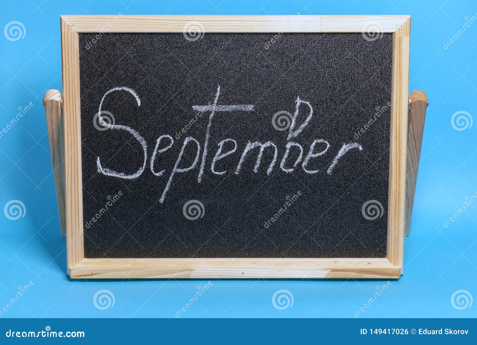 Blackboard with the Word Chalked September on Blue Background Stock ...