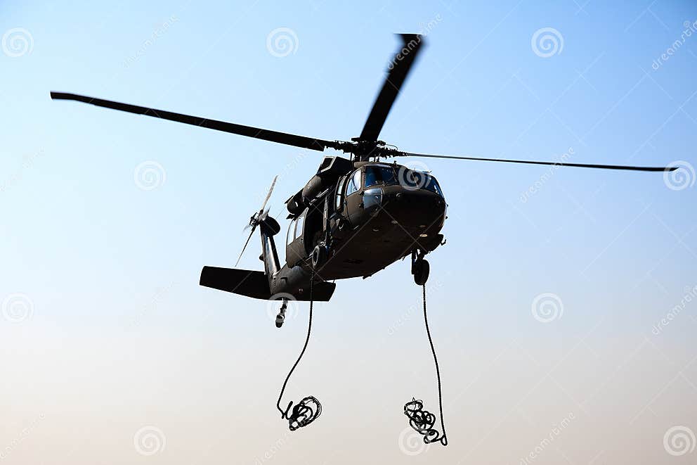 Blackhawk Dropping Ropes stock image. Image of transportation - 19934831