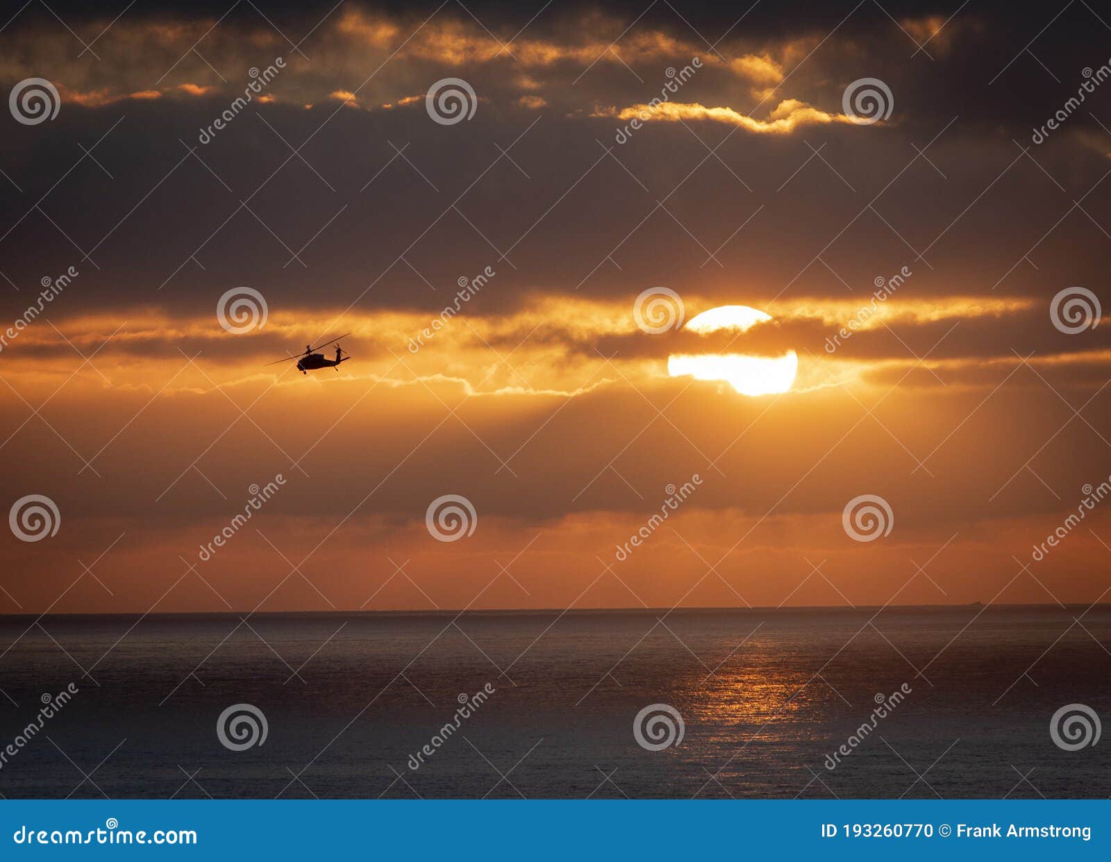 A Blackhawk Helicopter Banking Left Away from the Sun at Sunset Stock ...