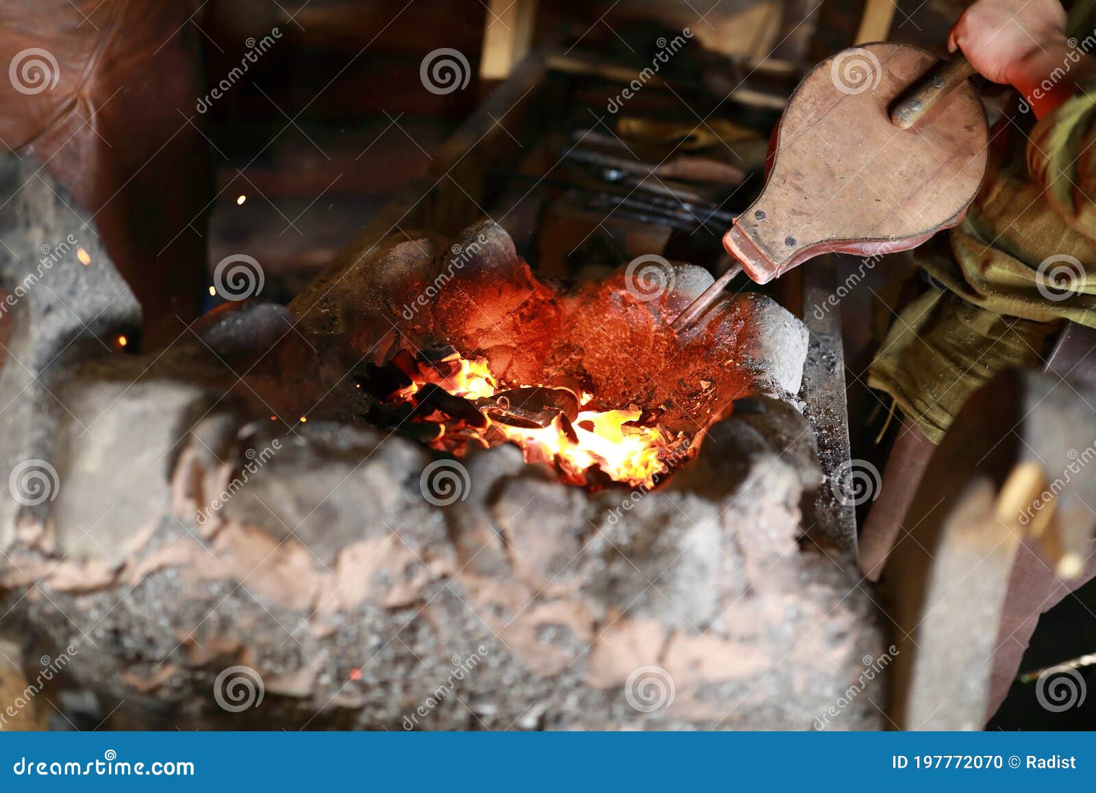 Blacksmith fanning fire stock photo. Image of industry - 197772070