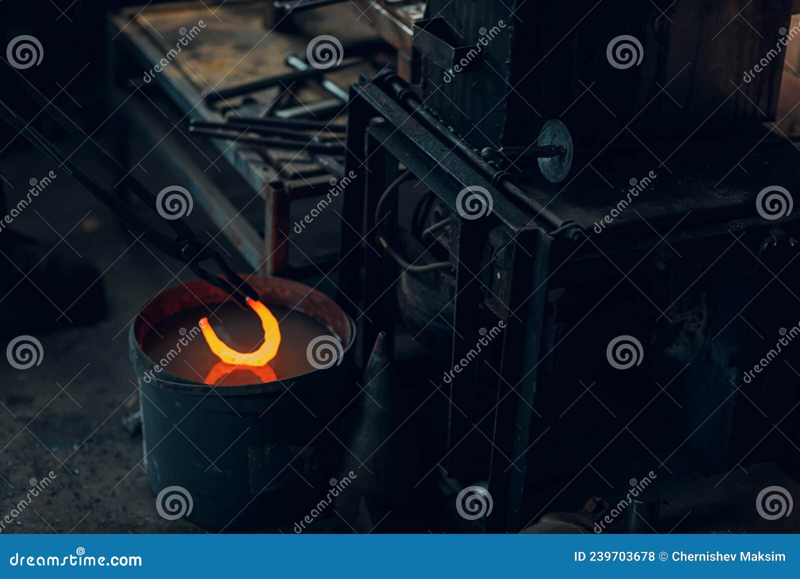 Blacksmith Forges and Tempering Metal Horseshoe in Jar with Water at ...