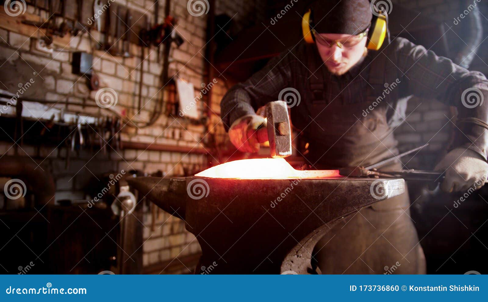Blacksmith Forging a Knife Blade in His Workshop Using a Hammer Stock ...