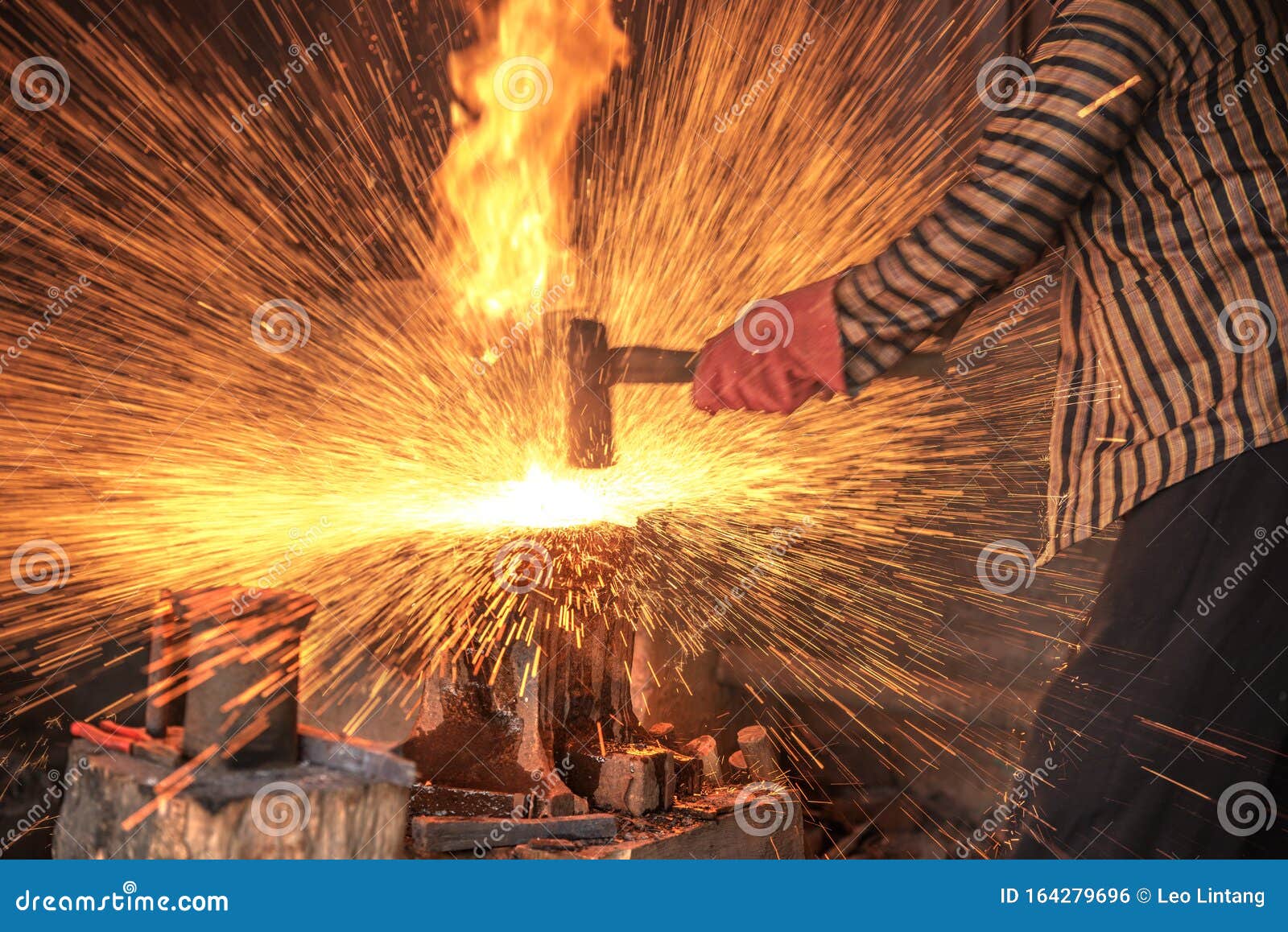 Blacksmith Forging the Molten Metal with a Hammer To Make Keris Stock ...
