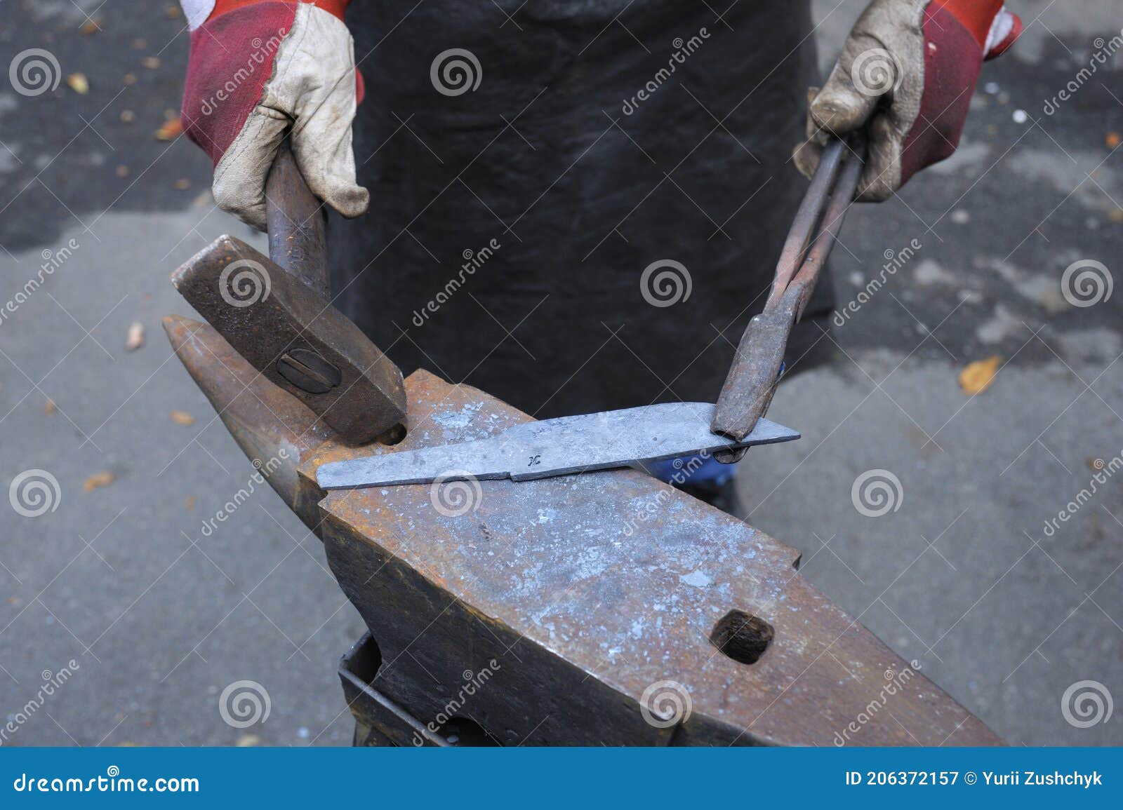Blacksmith`s Hands Sharpening A Carpenter`s Saw Using A Bench Grinder ...