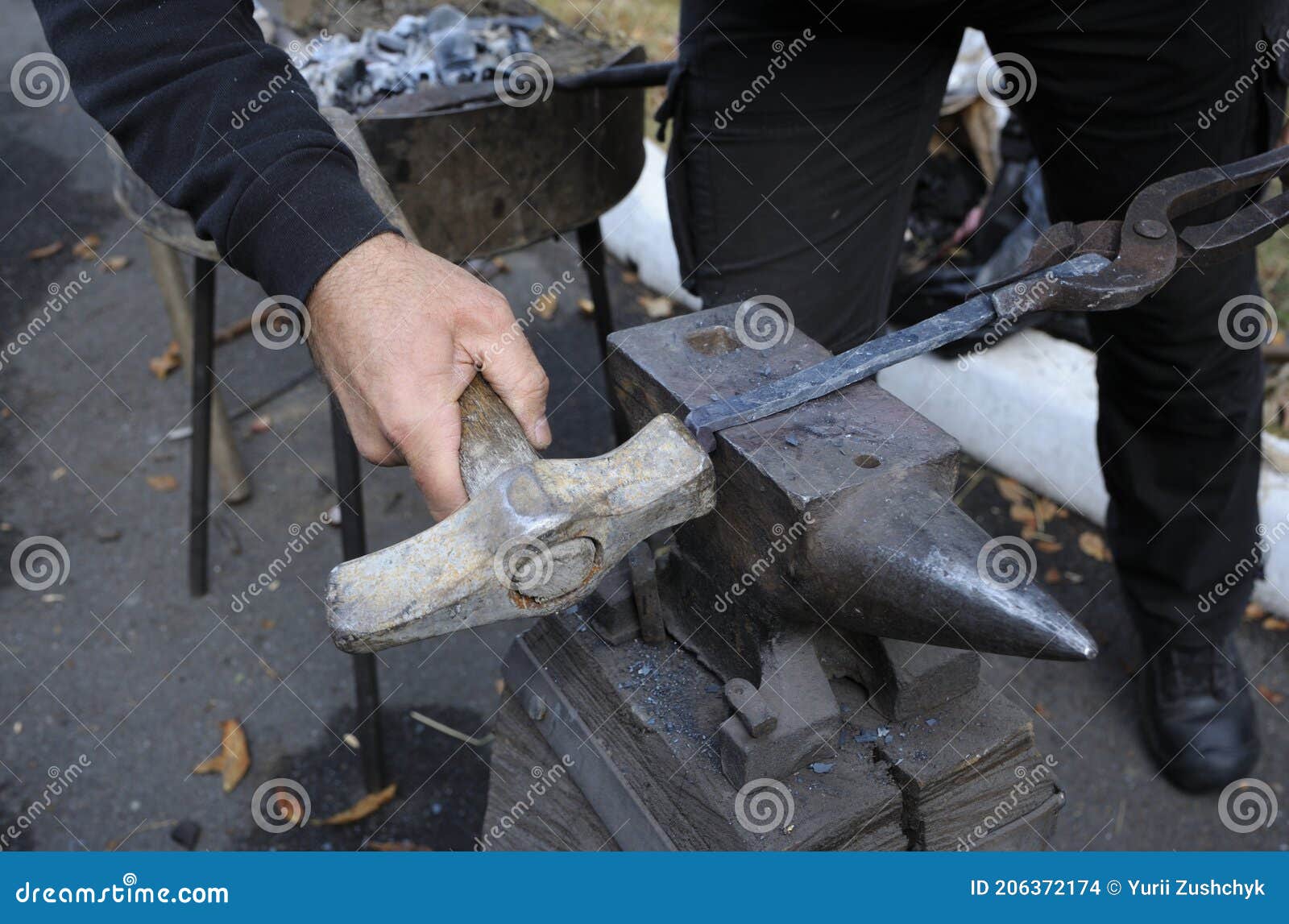 Blacksmith`s Hands Sharpening A Carpenter`s Saw Using A Bench Grinder ...