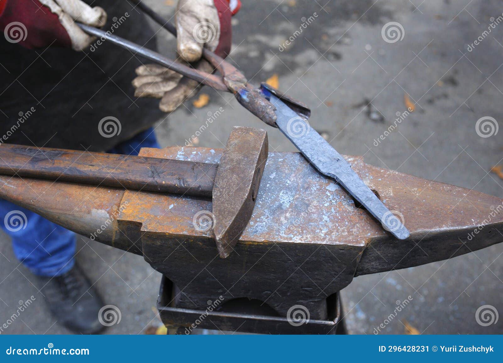 Blacksmith Hands Holding Forceps And A Hammer Forging A Metal Billet ...
