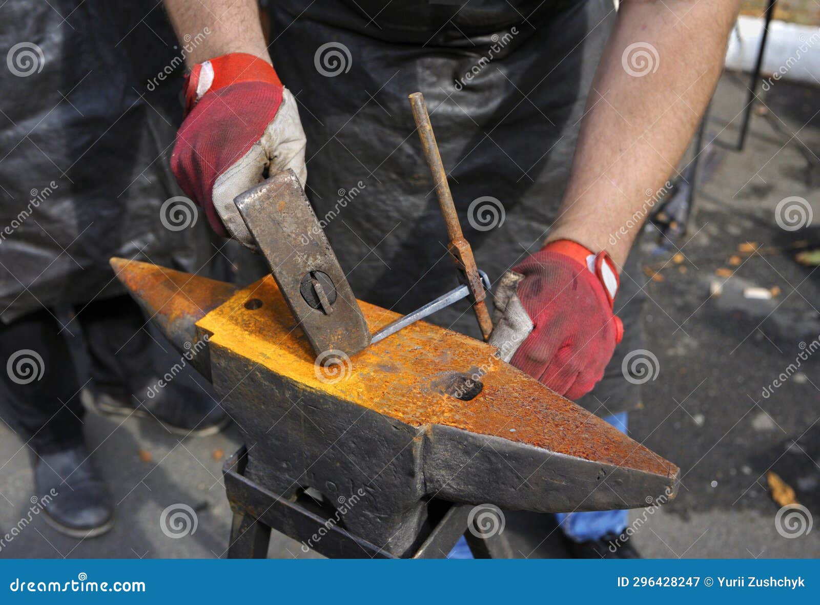 Blacksmith Hands Holding Forceps and a Hammer Forging a Metal Billet ...