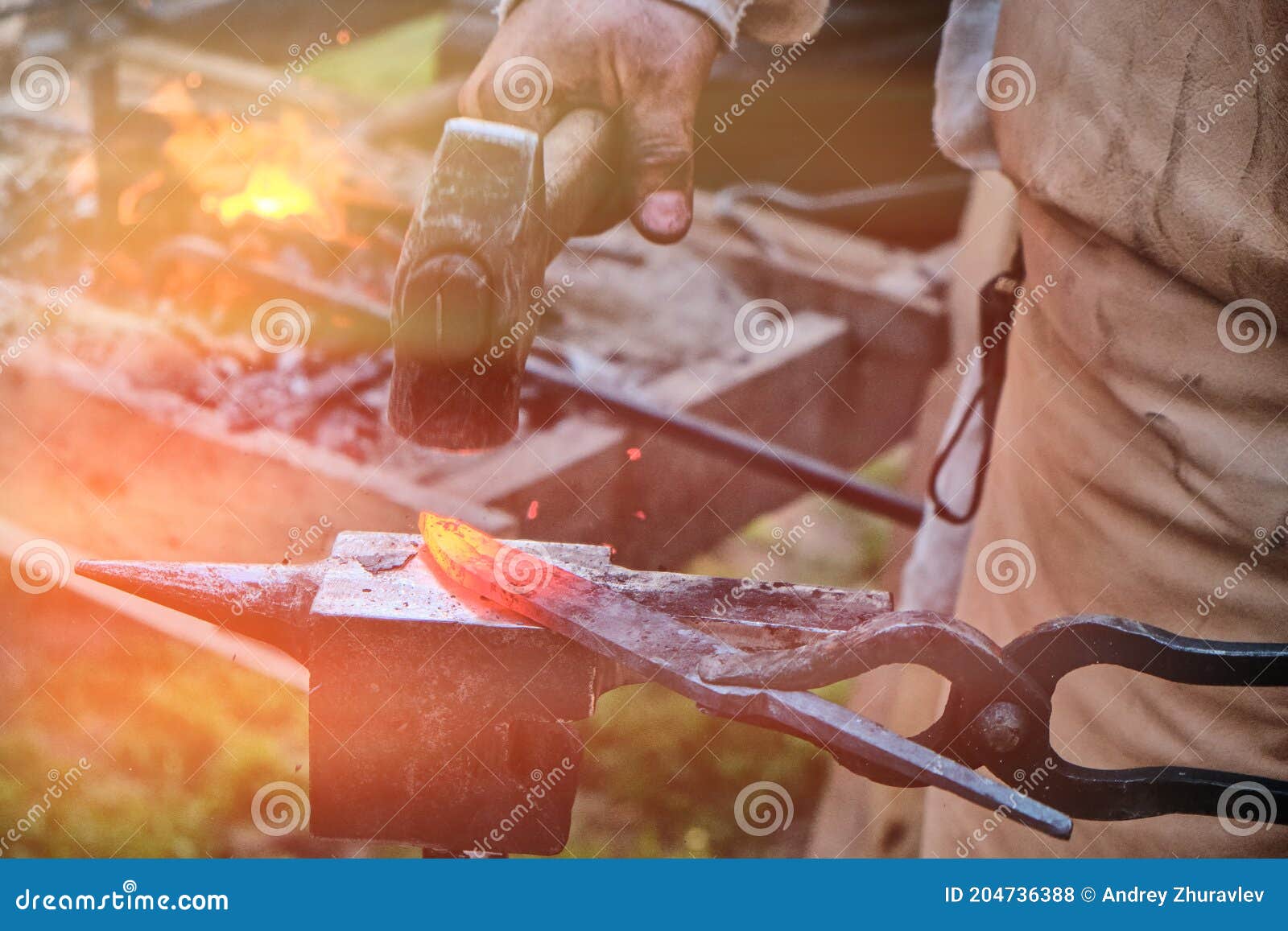 The Blacksmith Has a Hammer on Hot Iron. the Workpiece is Clamped in ...