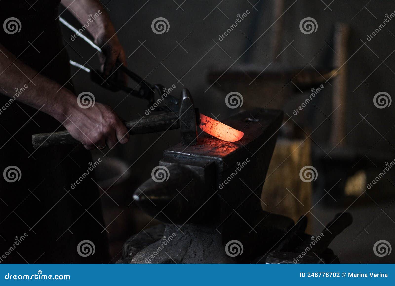 Blacksmith Hitting a Red-hot Iron with a Hammer Stock Photo - Image of ...