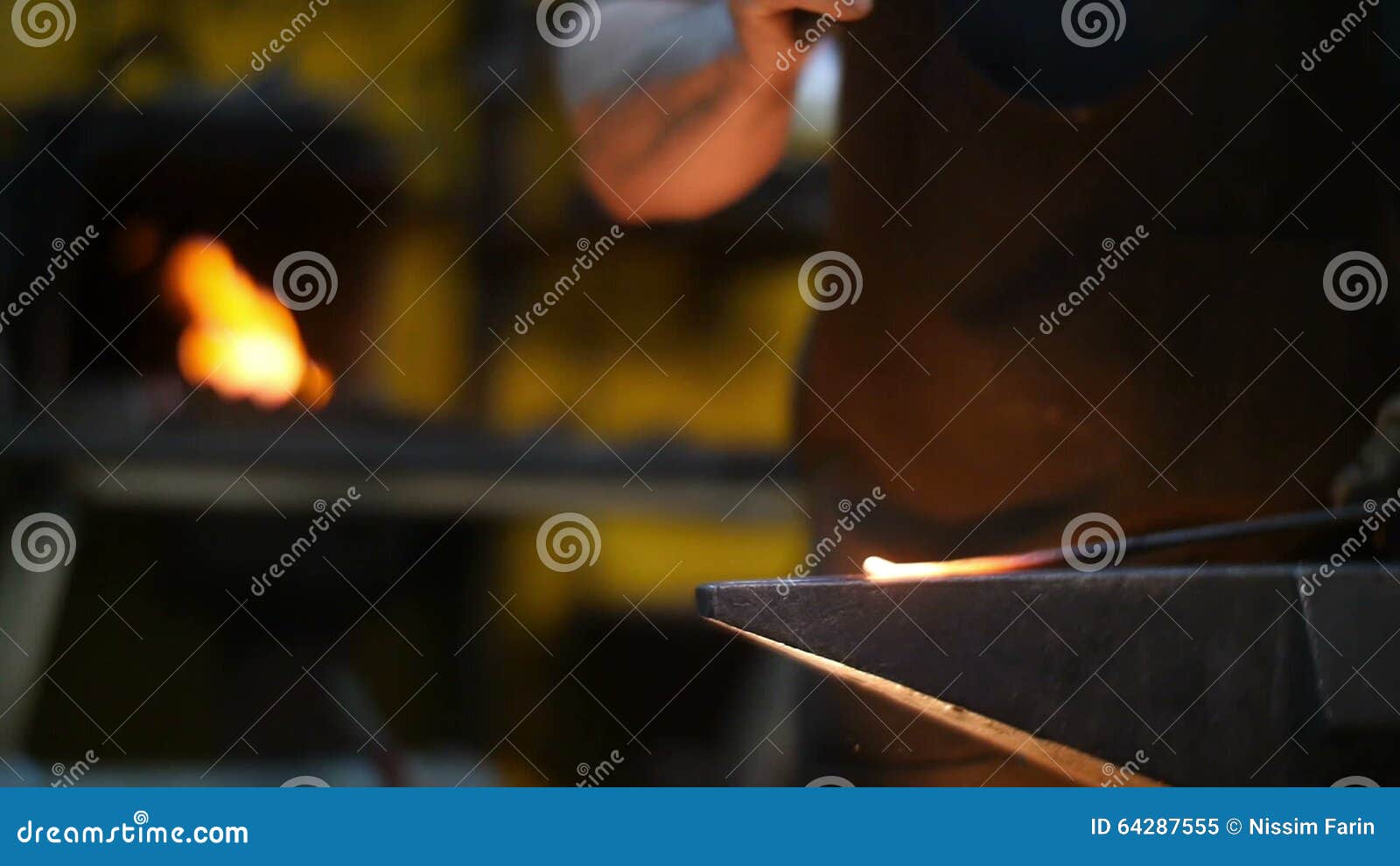 Blacksmith Hitting Hot Metal with a Hammer on an Anvil Inside His ...