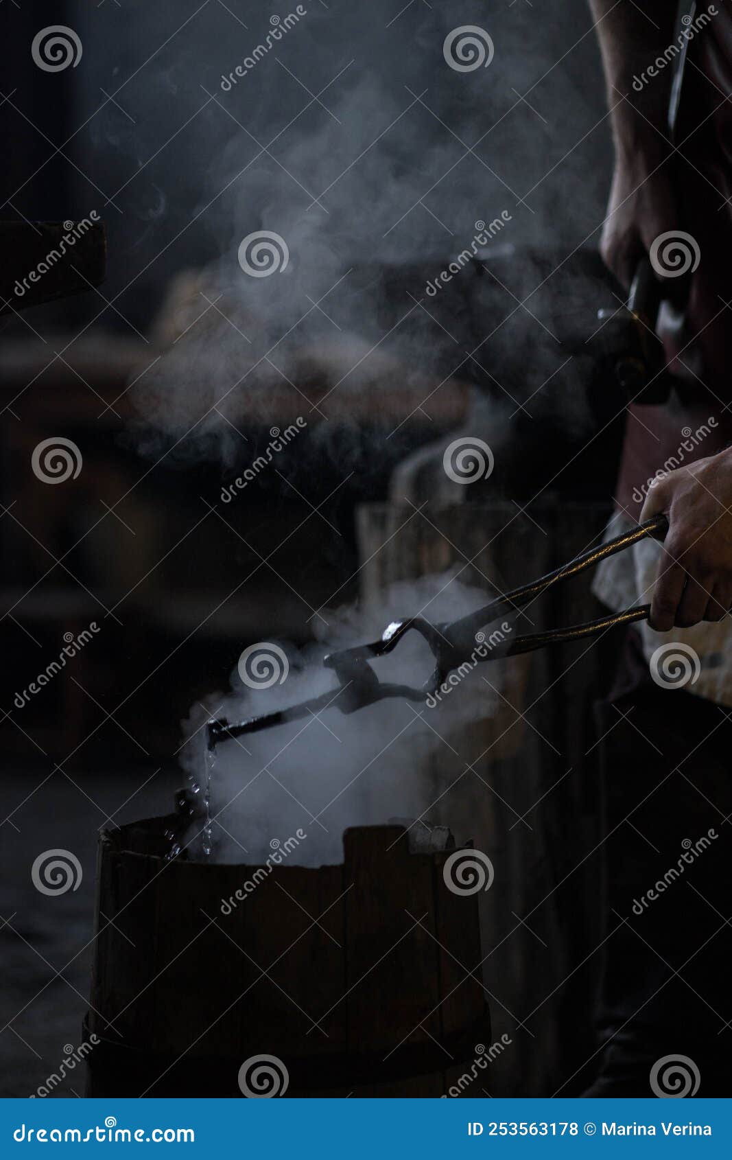 Blacksmith Holding Iron Work in Forge Stock Photo - Image of occupation ...