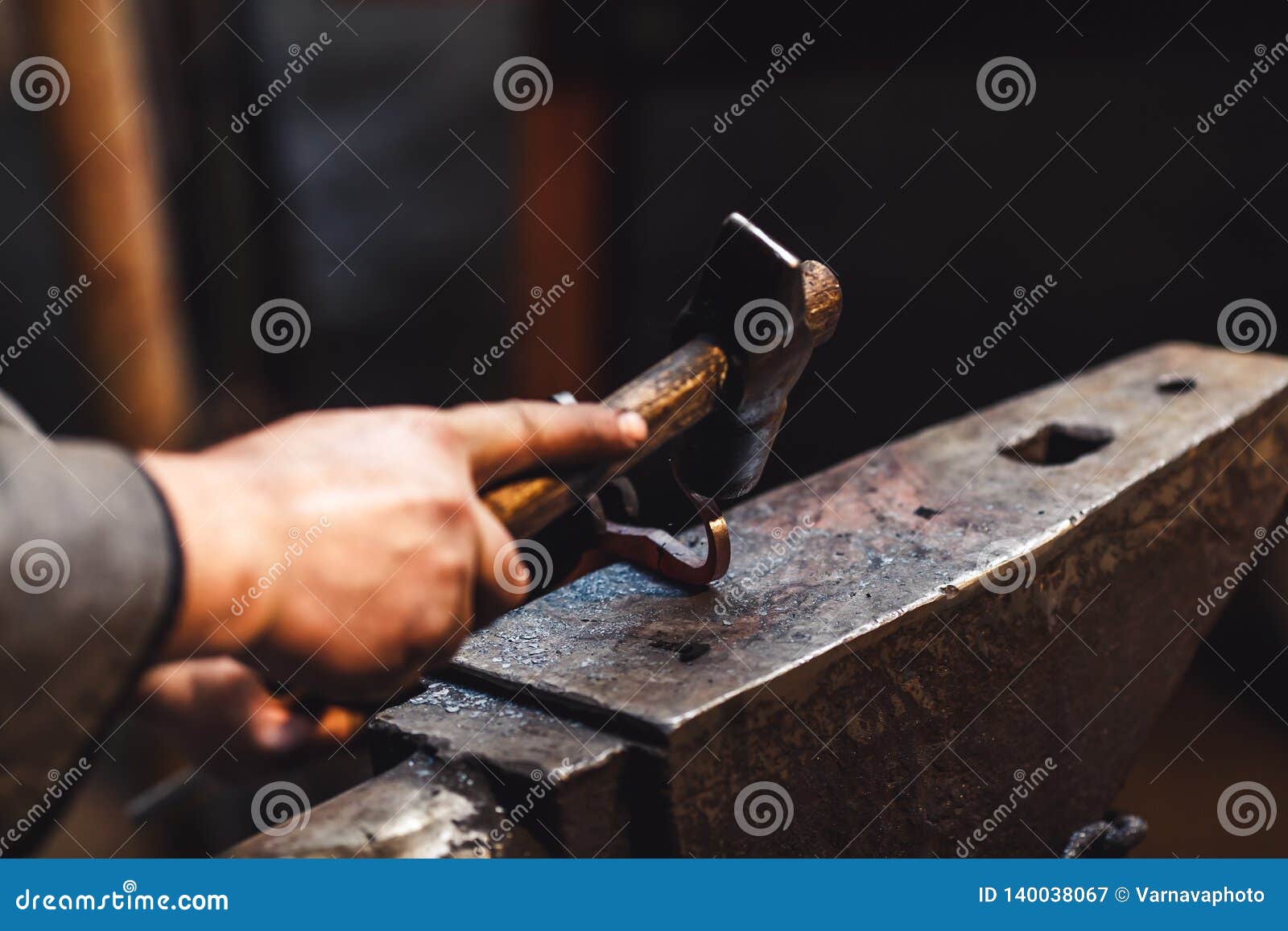 Blacksmith Makes an Artistic Forging of Hot Metal on the Anvil. Stock ...