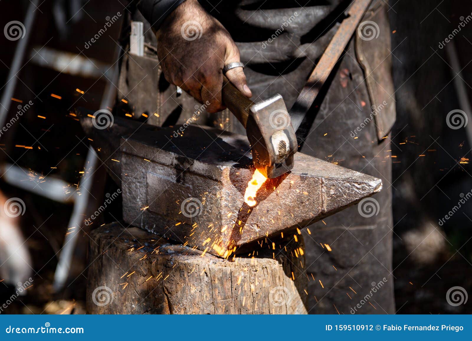 Blacksmith Manually Forging The Molten Metal On The Anvil In Smithy ...