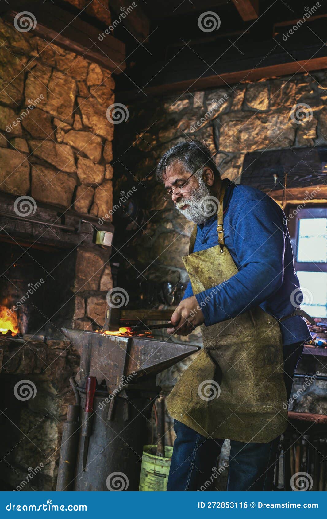 Blacksmith Manually Forging the Molten Metal on the Anvil in Smithy ...