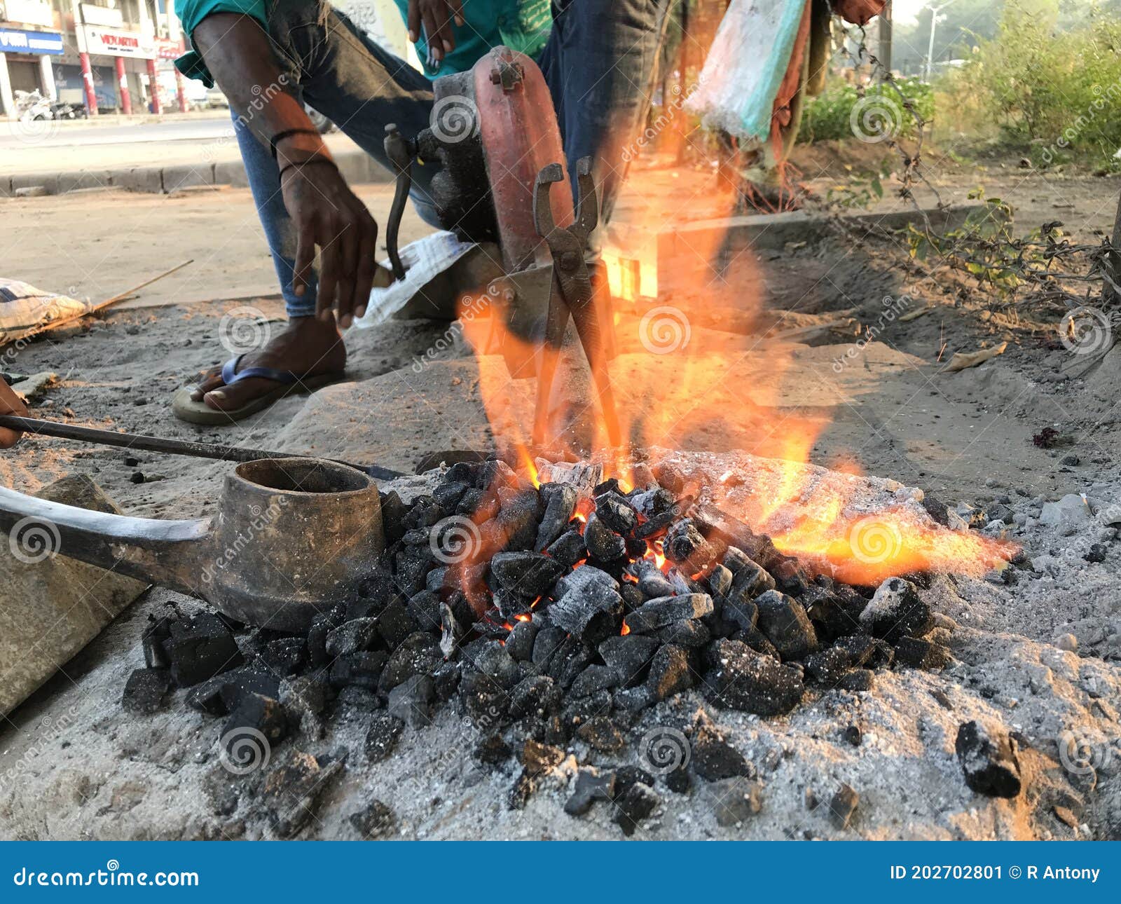 A Black Smith Forging in a Pick Axes on a Road Side Stock Image - Image ...