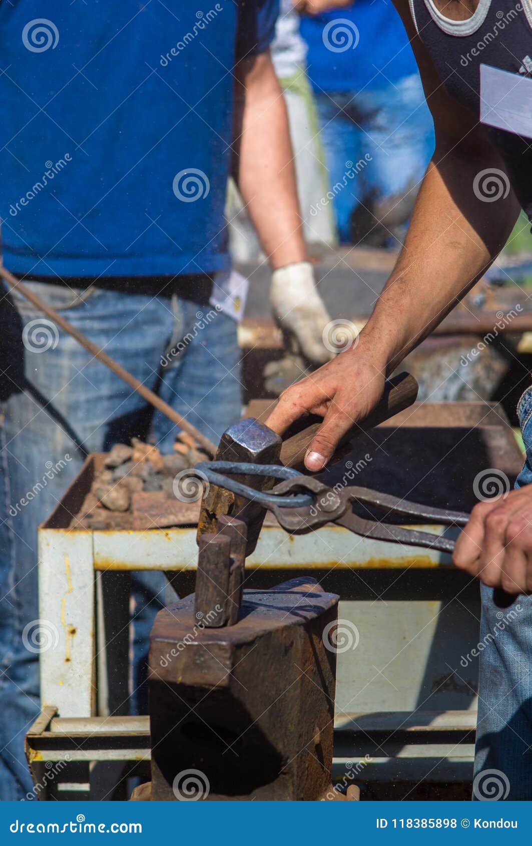 Blacksmith Performs the Forging of Hot Glowing Metal on the Anvil Stock ...