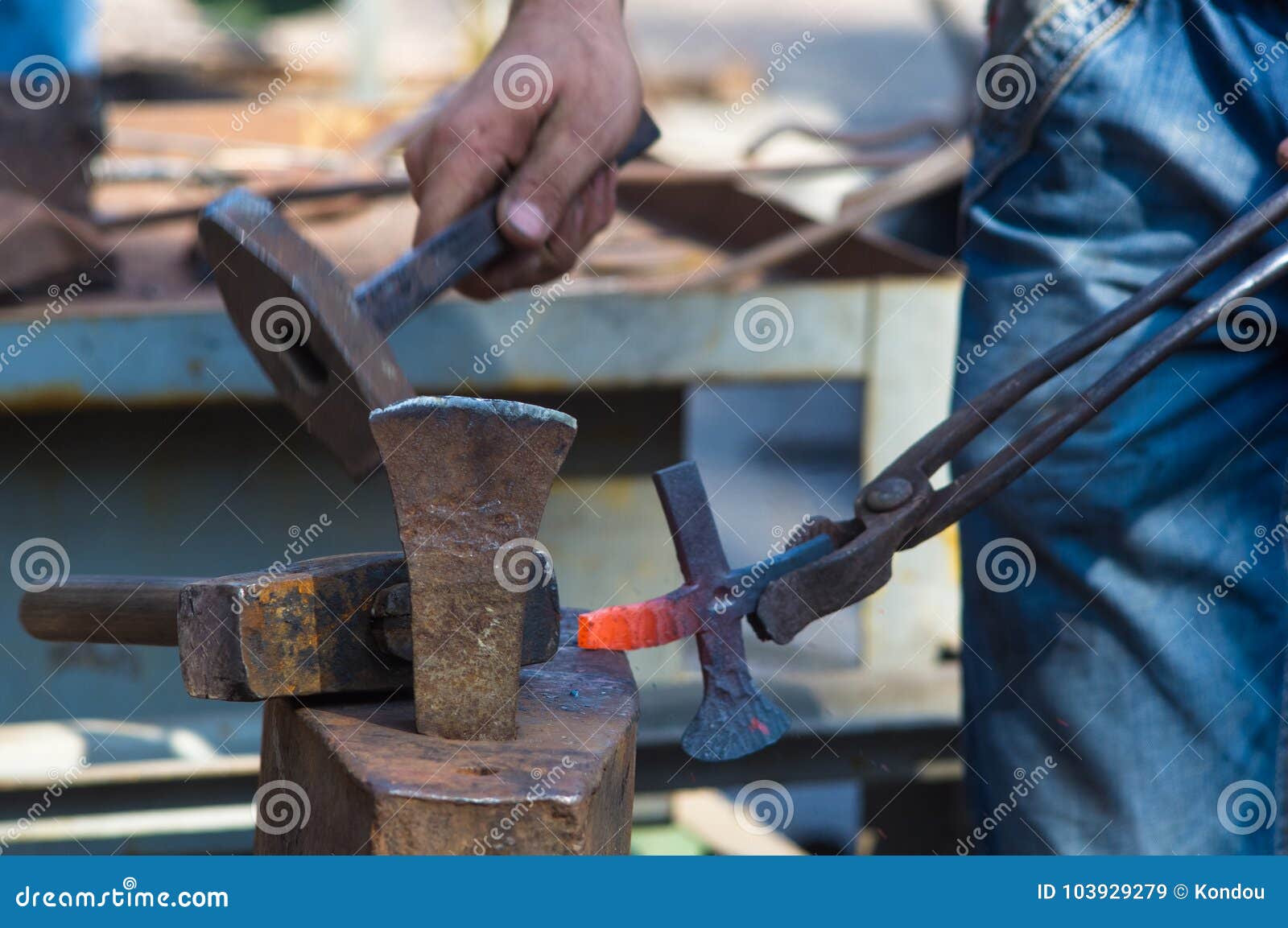 Blacksmith Performs the Forging of Hot Glowing Metal on the Anvil Stock ...