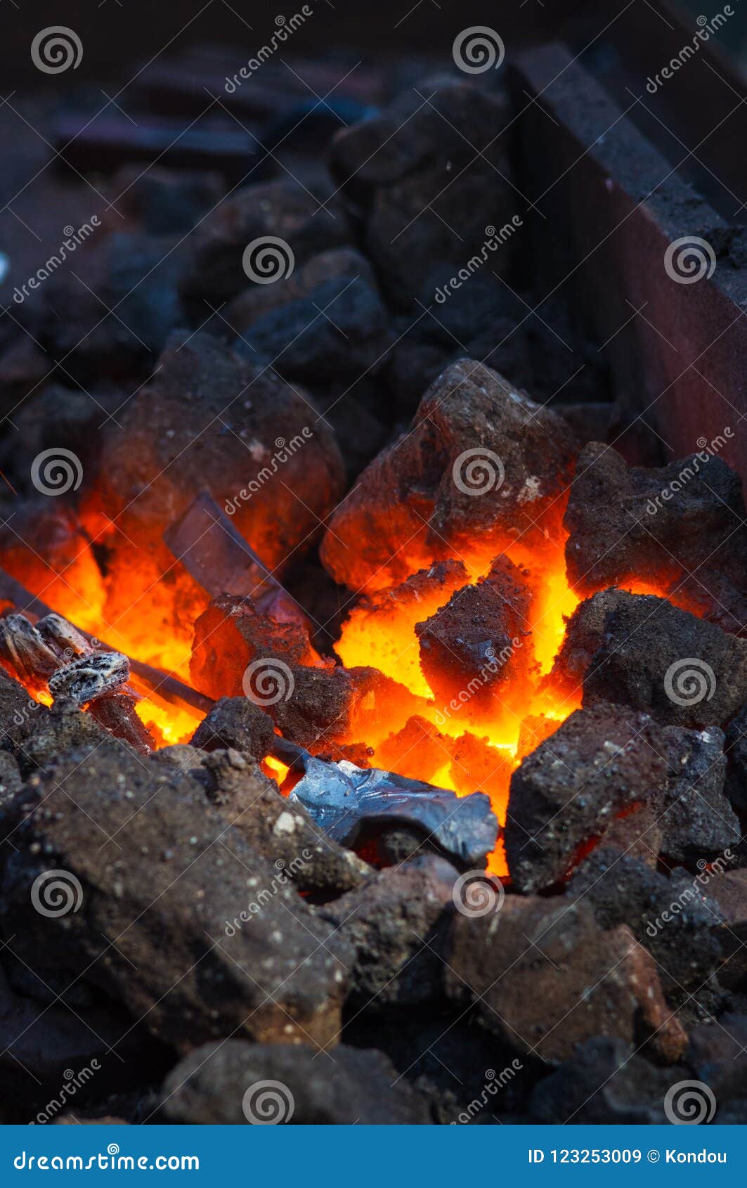 Blacksmith Performs the Forging of Hot Glowing Metal on the Anvil Stock ...