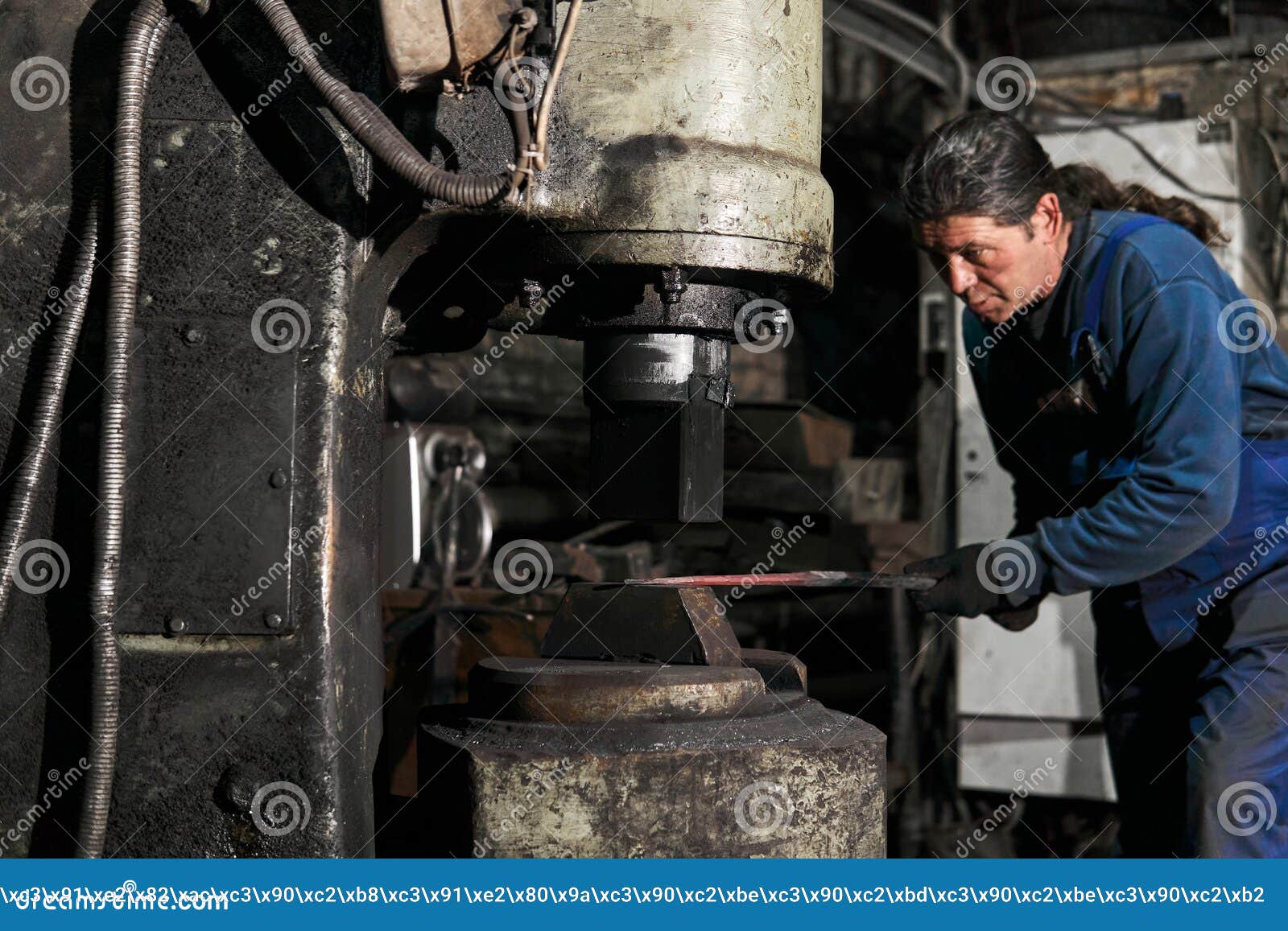 Blacksmith Processes a Hot Workpiece with a Machine Hammer Stock Photo ...