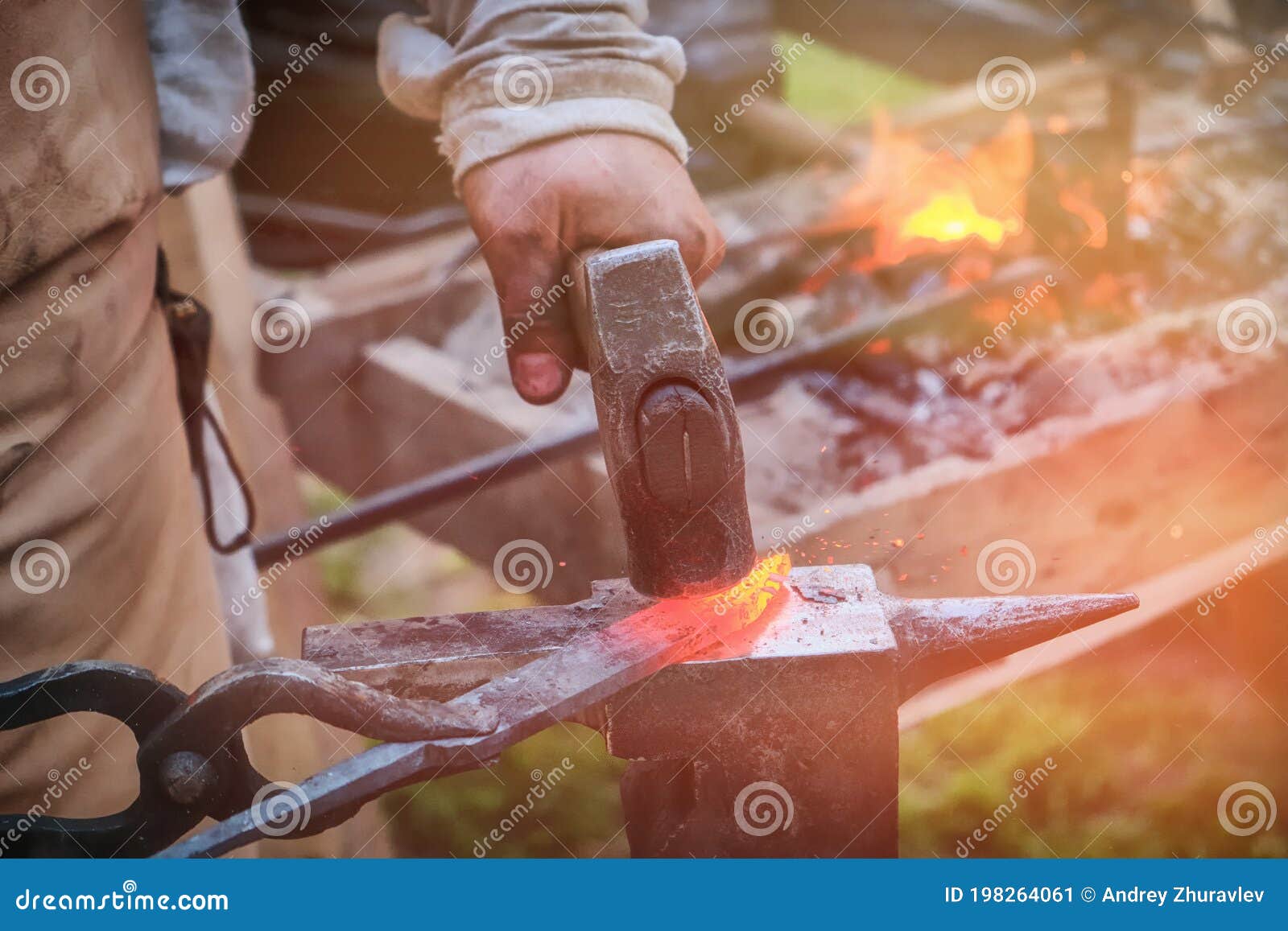 The Blacksmith Strikes the Red Blade of the Sword with a Hammer. Work ...