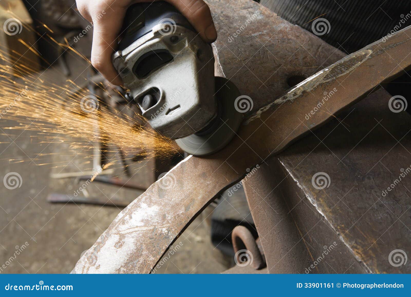 Blacksmith Using Angle Grinder on Edge of Metal Tool Stock Image ...